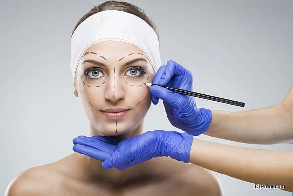 Beautiful woman with plastic surgery, depiction, plastic surgeon hands ...